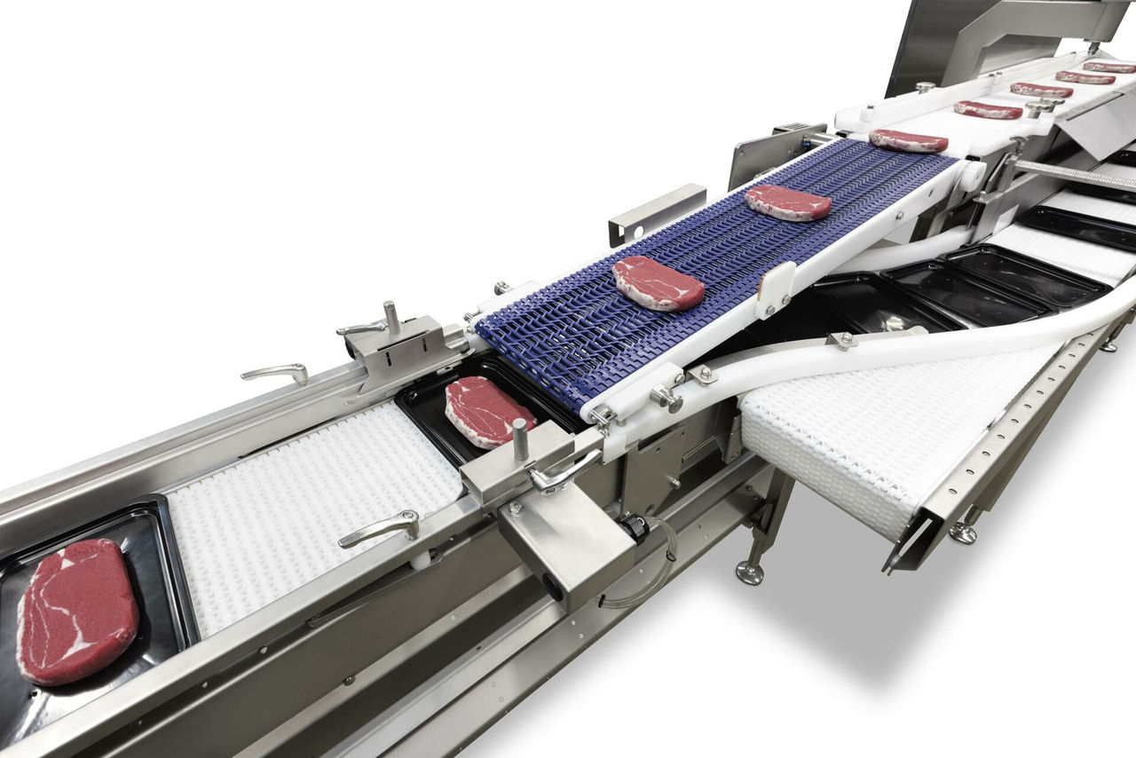 Automatic loading of sausage and meat products into the packaging ...